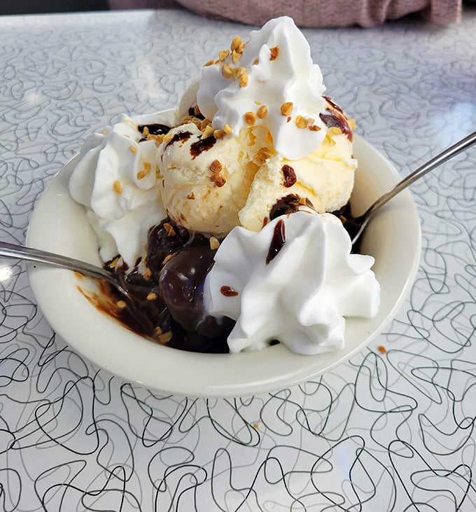 Hot fudge, cold ice cream, crunchy nuts—this sundae creates the kind of textural symphony that makes grown adults close their eyes in bliss.