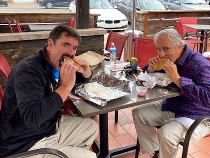 Two happy customers experiencing what philosophers call "sandwich nirvana" – that moment when all worldly concerns disappear between two pieces of bread.