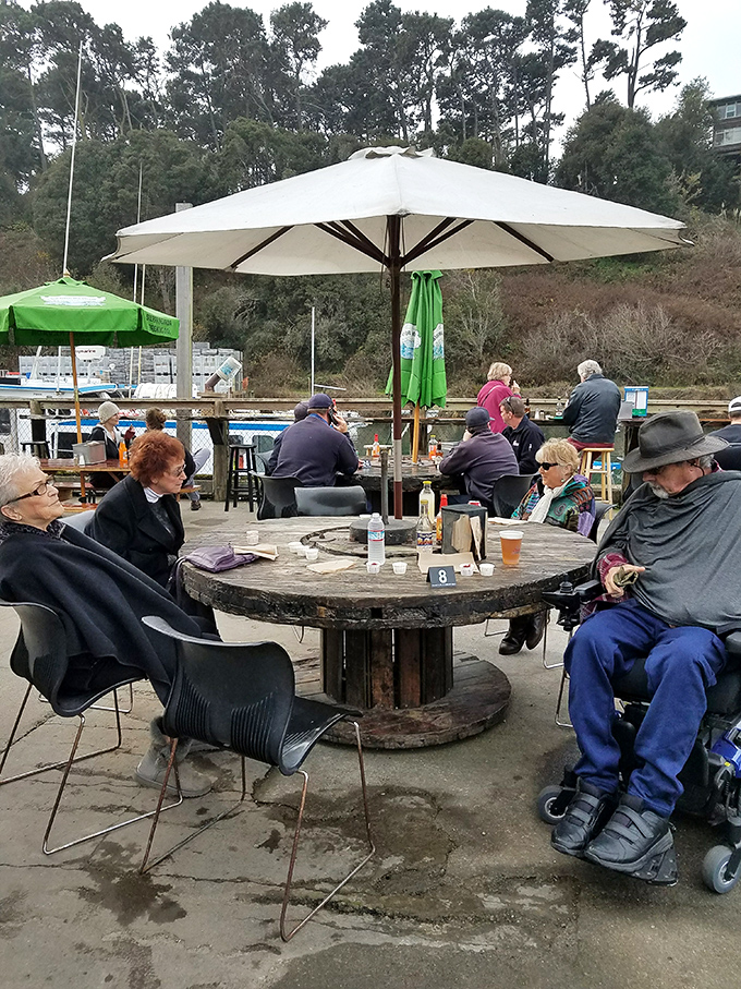 The outdoor dining area—where strangers become friends over shared appreciation of fried seafood and harbor views.