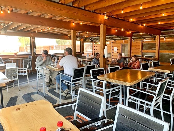 Where strangers become friends over the universal language of "Did you try the brisket?" Wooden beams frame culinary conversations.