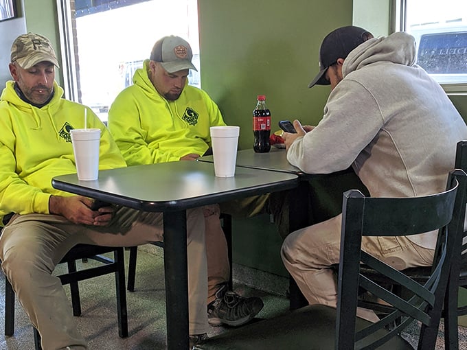 The lunchtime crowd knows the secret – these tables have witnessed countless "first bite" moments of pure sandwich bliss. Yellow hoodies optional, appetite mandatory.