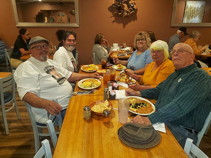 A gathering of happy diners proving that good food creates community. Those smiles aren't just from the company—they're from knowing what's about to hit their taste buds.