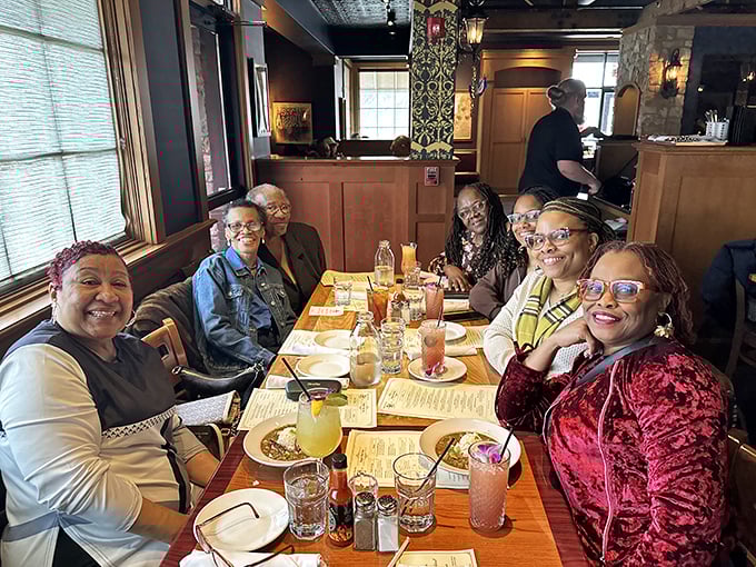 Happy diners gathered around a table of Cajun delights—proof that good food creates better conversation.