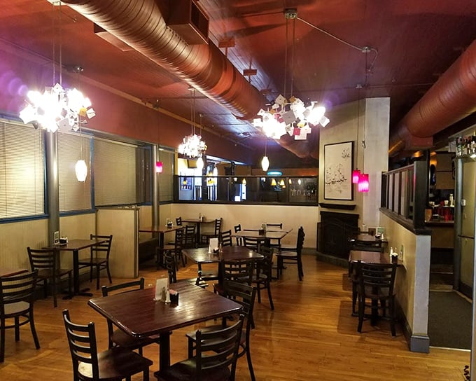 Another dining room angle reveals those conversation-friendly acoustics. The unique light fixtures assembled from what looks like found objects add whimsical character.
