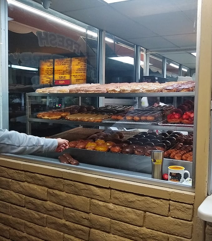 A glimpse behind the counter reveals the colorful array of donuts that make decisions nearly impossible and second visits inevitable.