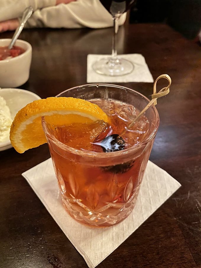 This isn't just another Old Fashioned—it's liquid amber with an orange twist that whispers, "The steak is coming, but let's enjoy this moment first."