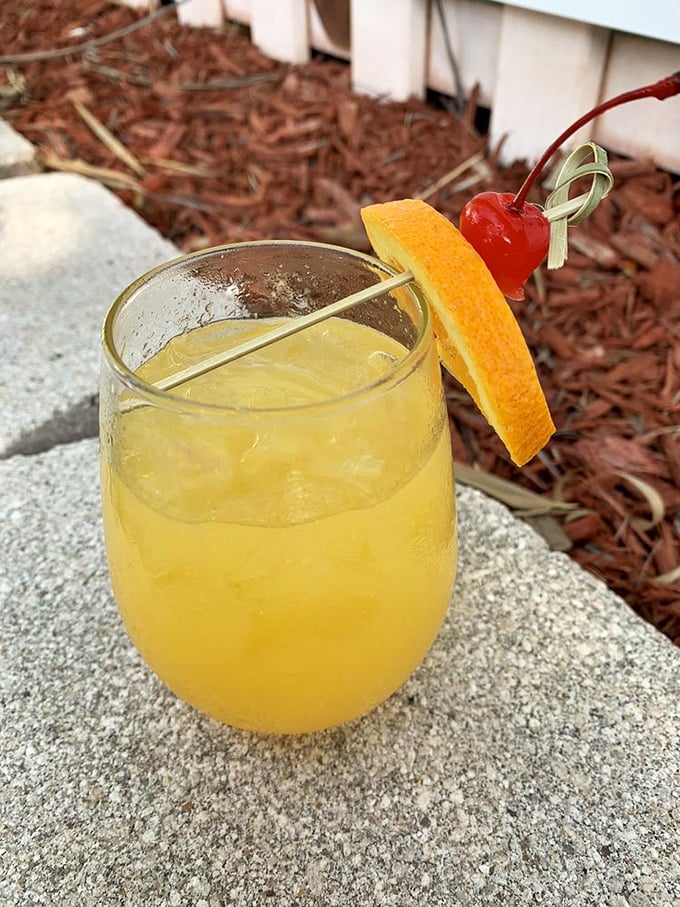 A sunshine-colored cocktail with the perfect orange garnish—because sometimes your drink deserves to dress up for the occasion too.