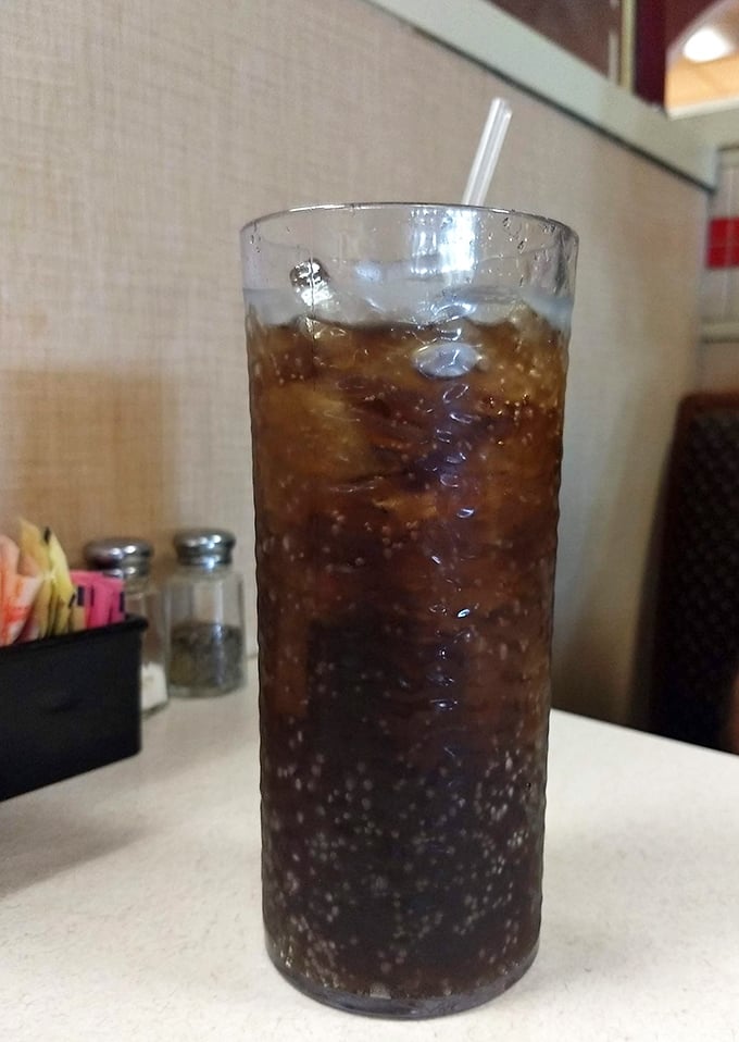That tall glass of cola isn't just a beverage—it's the perfect companion for cutting through rich comfort food, bubbles dancing all the way down.