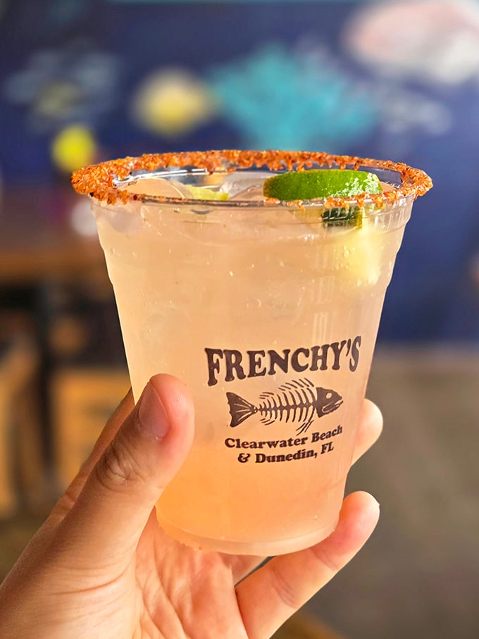A perfectly salted rim frames this refreshing cocktail like a halo. Nothing says "vacation mode activated" quite like a cold drink with the Frenchy's fish skeleton logo.
