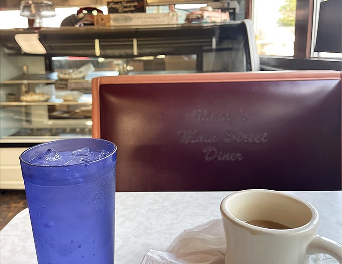 Classic diner beverages served in their natural habitat – a blue soda alongside coffee in a sturdy white mug, the fuel for countless Ohio conversations.