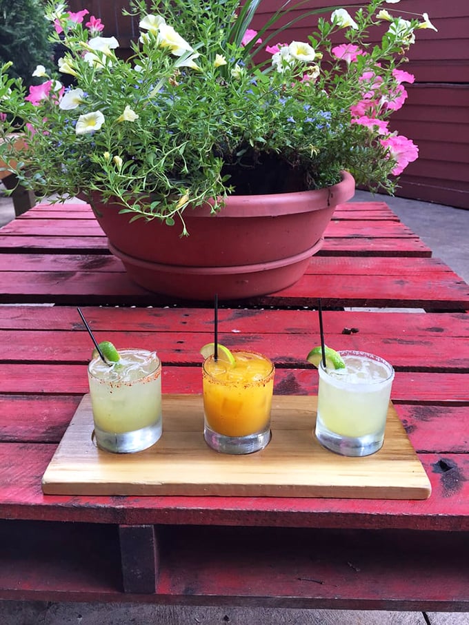 A trio of margaritas on the patio—each glass a different hue, each sip a different adventure, each moment a different reason to order another round.