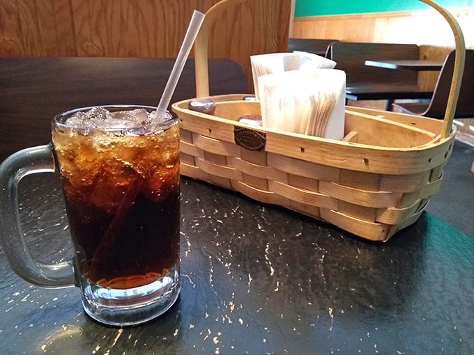 Nothing fancy here—just an honest soda in a proper mug alongside a napkin basket that says, "We know you're about to enjoy something messy."