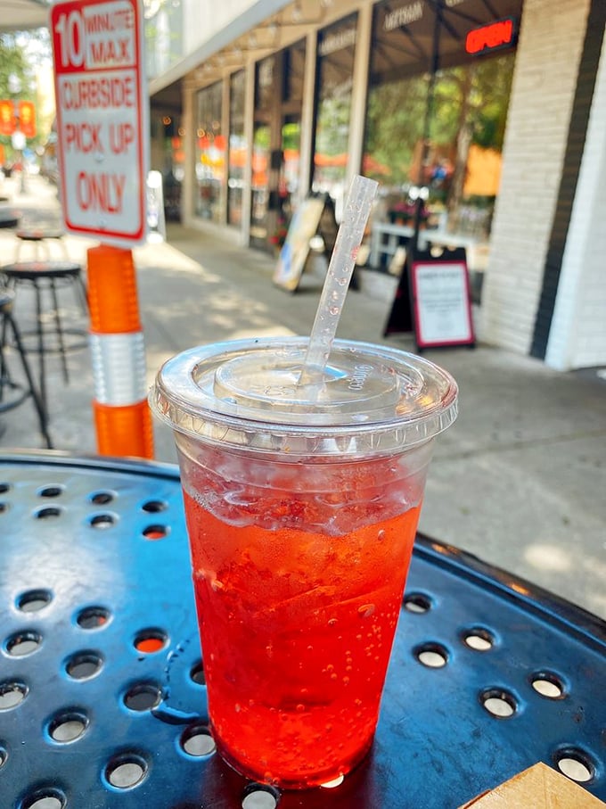 That vibrant red drink isn't just refreshing—it's like summer in a cup, the perfect cool counterpoint to Harrell's hot dog heat.