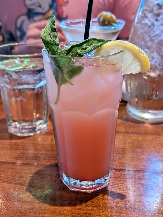 This isn't just a cocktail; it's summer in a glass, complete with basil leaves playing the role of tiny refreshing umbrellas.
