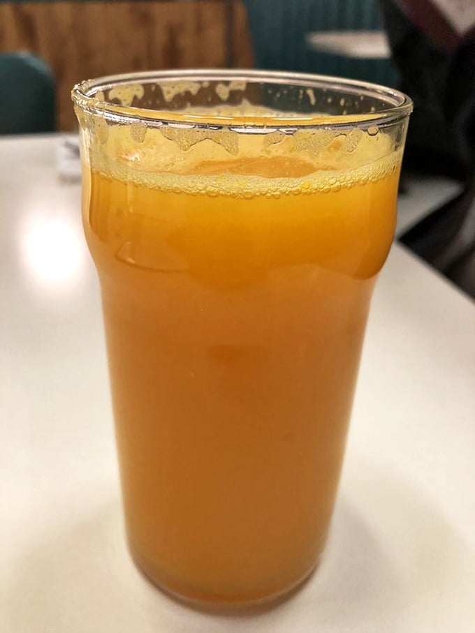 Fresh-squeezed orange juice that's actually the color nature intended. No neon science experiments here—just pure sunshine in a glass.