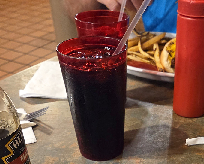 Those red plastic cups hold more than just soda – they contain the essence of American diner tradition, cold and refreshing.