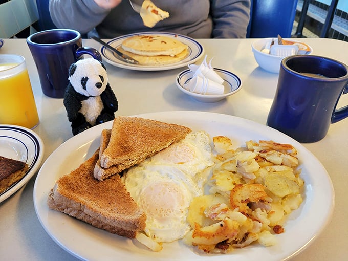 The breakfast trinity: perfectly cooked eggs, crispy home fries, and toast waiting to soak up that glorious yolk. Morning salvation on a plate.