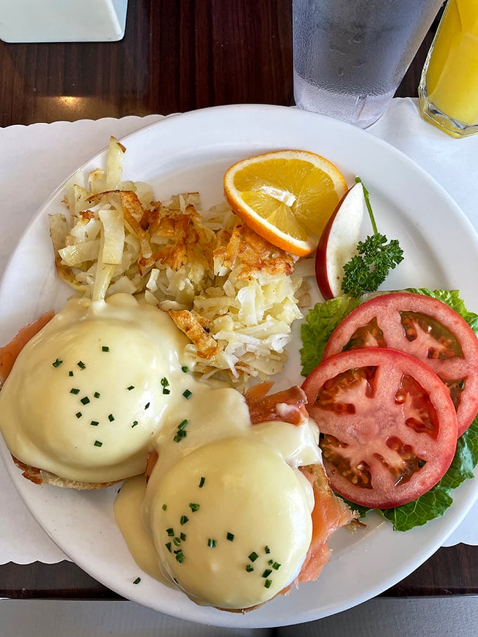 Eggs Benedict done right—where hollandaise sauce cascades like a yellow waterfall over perfectly poached eggs, creating breakfast's most elegant magic trick.