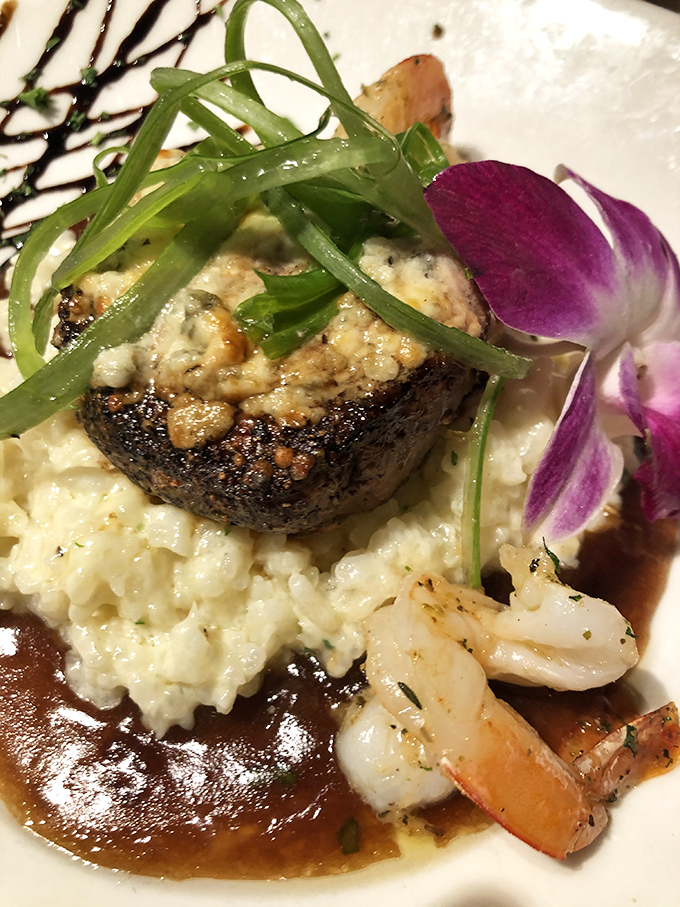 Surf meets turf in perfect harmony—a beautifully seared steak crowned with blue cheese, accompanied by shrimp that didn't travel far to reach your plate.