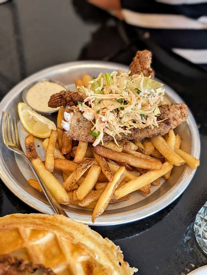 Crispy catfish and golden fries that could make a Frenchman weep. The slaw adds crunch and color to this Southern seafood symphony.