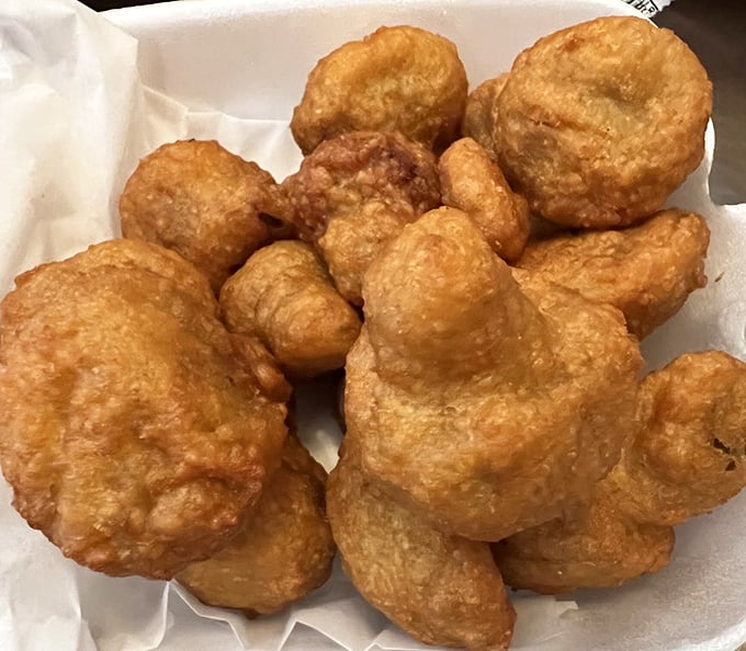 Fried mushrooms that achieve the impossible – maintaining their earthy essence while wearing a perfectly seasoned golden armor of crispy batter.
