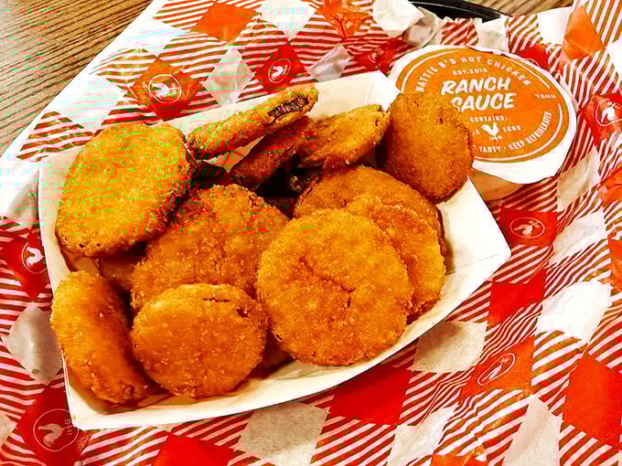 Golden fried pickles arrive like crispy little life preservers in your sea of spice.