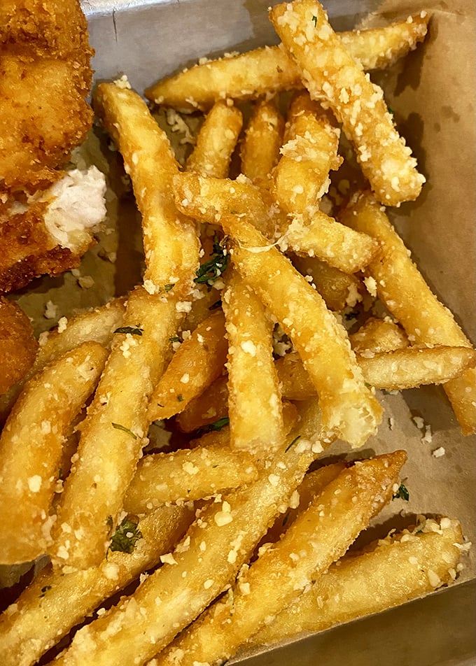 Parmesan fries that deserve their own fan club. Crispy, golden, dusted with cheese—they're what regular fries dream of becoming when they grow up.