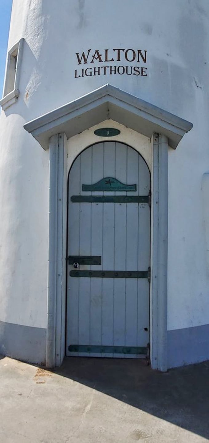 The lighthouse door – both inviting and off-limits – features nautical details that hint at the maritime heritage of this coastal sentinel.
