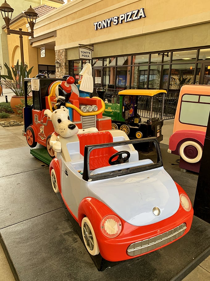 Tiny fire trucks and character cars create a mini Disneyland, keeping little ones happy while parents pursue retail therapy.