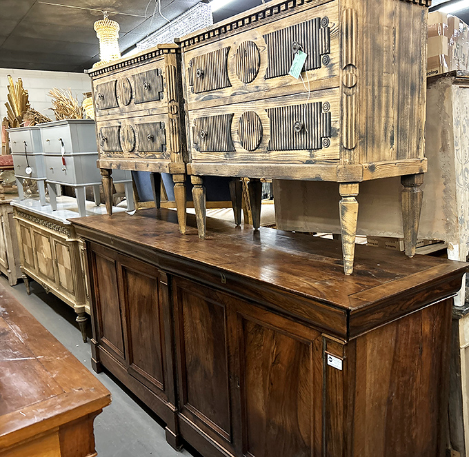 Weathered wood meets elegant design in this furniture display. These aren't just dressers and cabinets—they're time capsules with drawers.