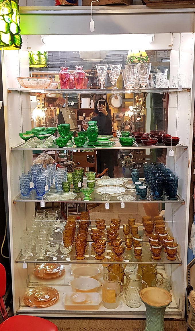 A rainbow of vintage glassware organized with the precision of a museum curator with OCD. Those amber goblets have "holiday dinner party star" written all over them.