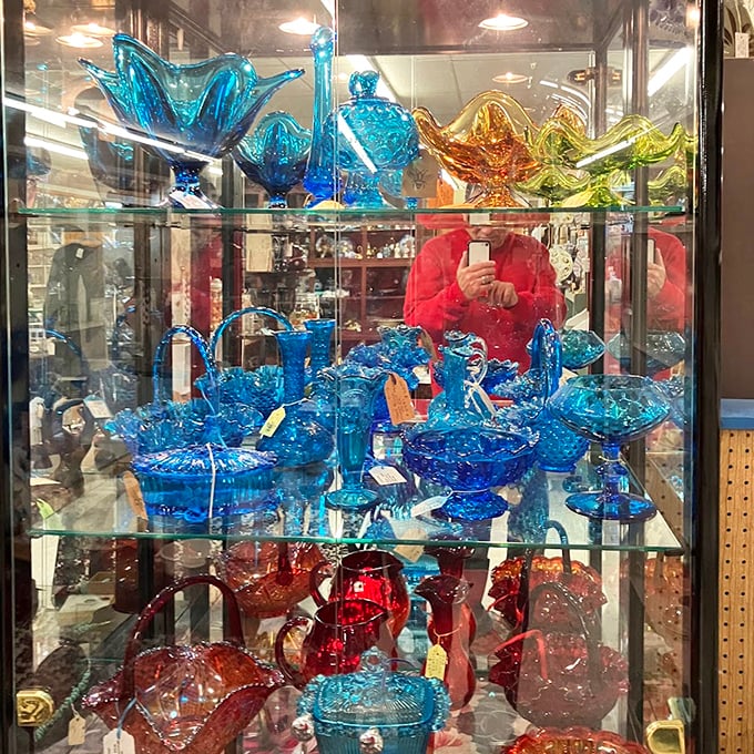The blue glassware collection glows like an underwater treasure trove—each piece more vibrant than the last, making modern reproductions look positively anemic by comparison.