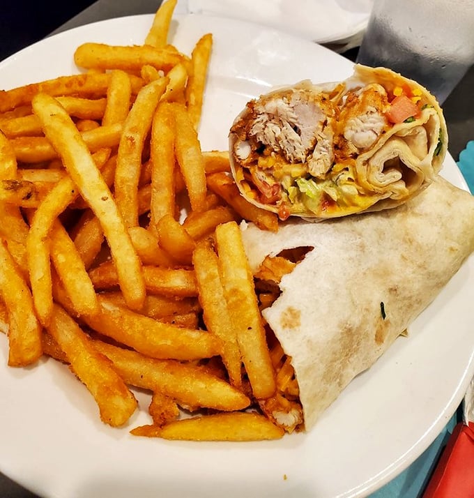 This wrap isn't just holding ingredients—it's cradling dreams. Golden fries standing by like loyal friends ready to complete your happiness.