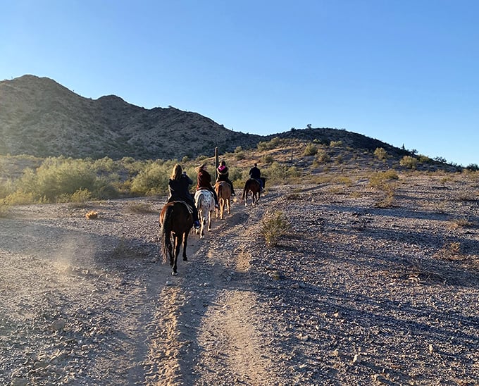 Giddy-up into the golden hour! These riders are experiencing the desert the way it was meant to be seen – from horseback, with mountains as your compass.