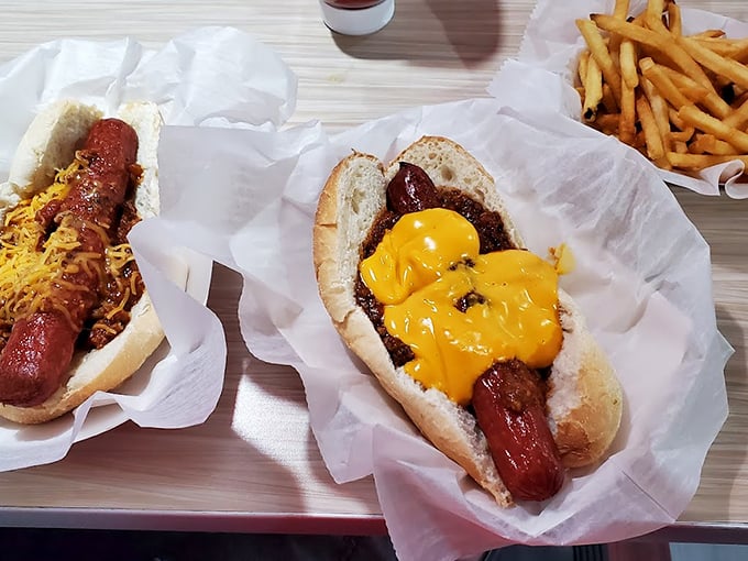 Hot dogs done right – nestled in soft buns and smothered with chili and cheese that transforms this simple ballpark staple into something magical.