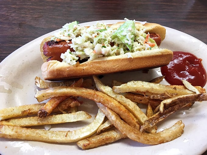 Hot dogs get the respect they deserve here. This loaded beauty, topped with fresh slaw, reminds us that simplicity and satisfaction often travel together.