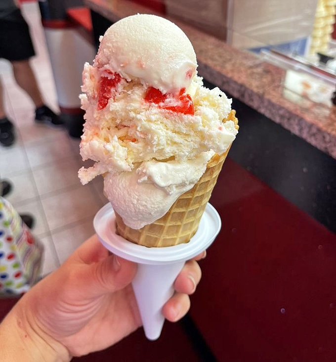 This isn't just ice cream – it's architecture. A waffle cone cathedral housing strawberry-studded vanilla that makes adults remember what wonder feels like.