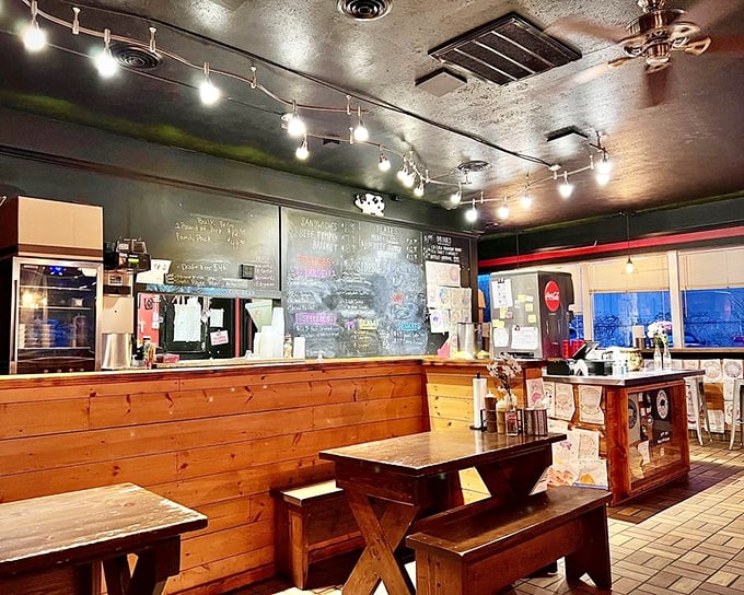 The dining area's warm wood and track lighting create that rare atmosphere where strangers become temporary friends united by barbecue bliss.