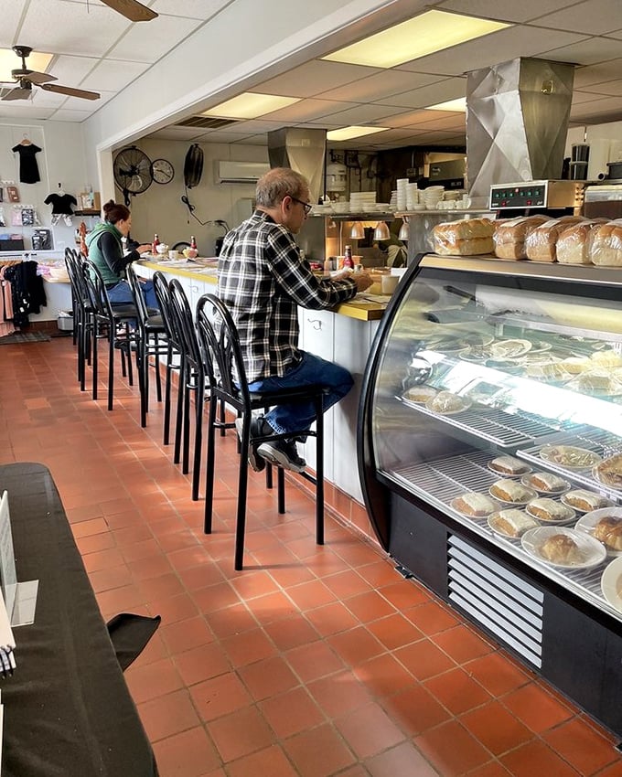 The counter seating offers a front-row view to the pastry case—nature's way of ensuring you'll never leave without dessert.