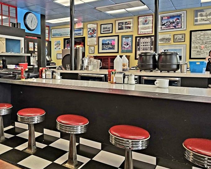 Classic diner counter culture lives on with these red stools and checkered floors. This isn't retro design—it's authentic Americana preserved like a time capsule.