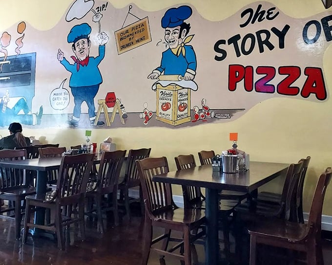 "The Story of Pizza" mural watches over diners like a delicious history lesson. These wooden chairs have supported countless happy eaters.
