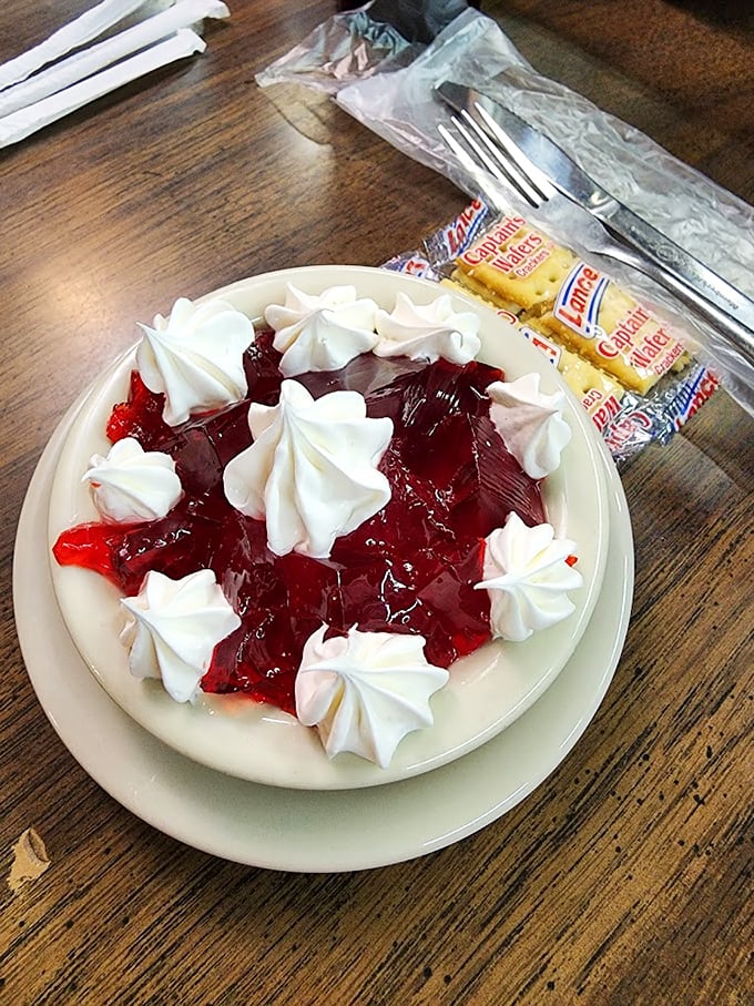 Jello elevated to art form status with perfectly piped whipped cream—dessert masquerading as breakfast and nobody's complaining.