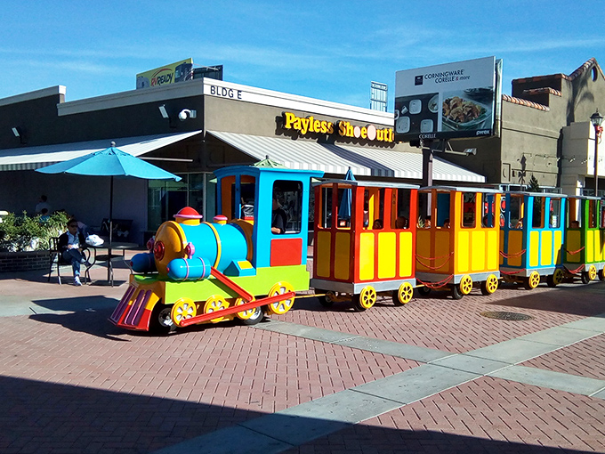 The colorful kiddie train – keeping the little ones entertained while you debate whether you really need another pair of discounted designer sunglasses.