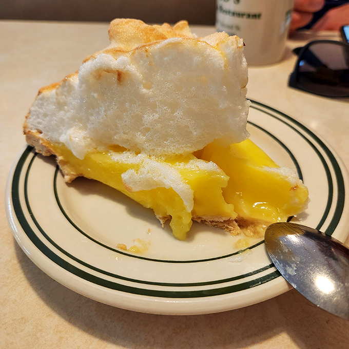 Lemon meringue pie with a cloud of sweet meringue floating above tangy lemon filling—proof that heaven exists and it's on a plate at Bud's.