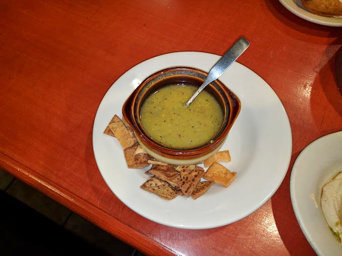 This lentil soup isn't playing around—it's serious comfort in a bowl, with a supporting cast of perfectly toasted pita triangles ready for their dipping debut.
