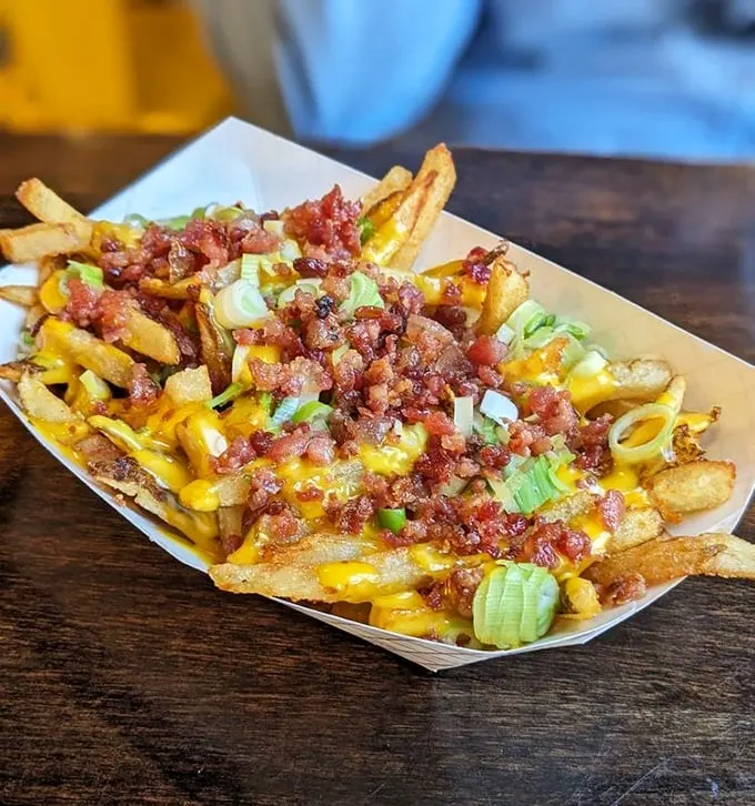 These aren't just loaded fries – they're a commitment to excess done right. Bacon, cheese, and green onions transform potatoes into a celebration.