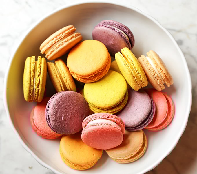 A rainbow gathering of macarons that makes you wonder if cookies can have better social lives than humans.