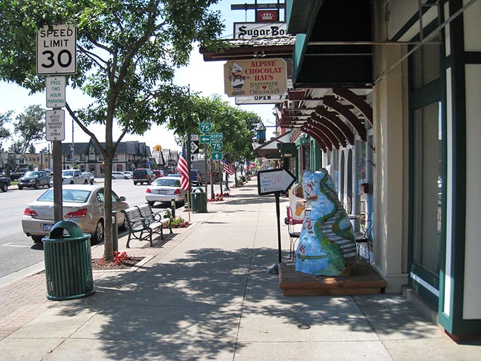 Downtown sidewalks lined with colorful planters and quirky dinosaur statues—because nothing says "Alpine Village" quite like prehistoric reptiles.