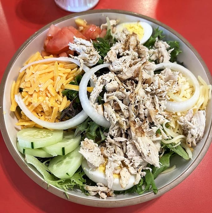Fresh, vibrant, and colorful—this salad proves that healthy eating doesn't have to be punishment, especially with that perfectly seasoned chicken on top.