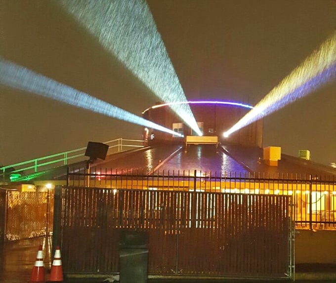 Movie magic begins here—projection beams slice through the night air, creating a light show worthy of a Pink Floyd concert.